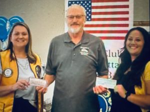 Historical Society Board Member Tony Collett (center) accepts checks ...